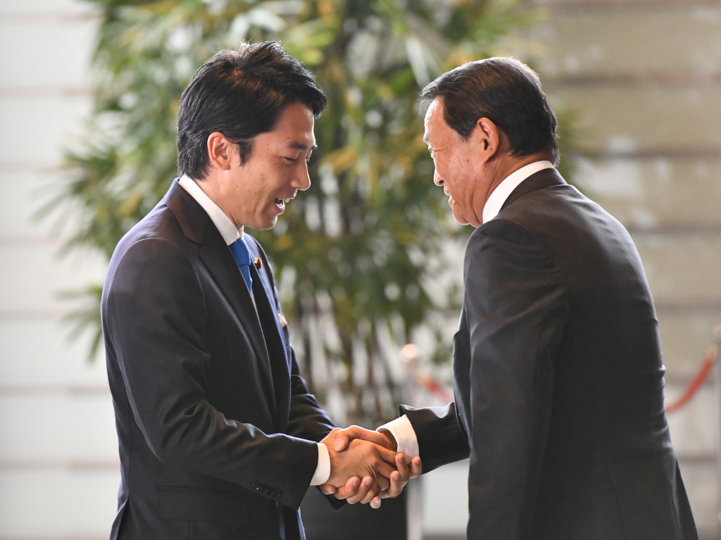 Japan's Abe shakes up cabinet, brings in rising star
