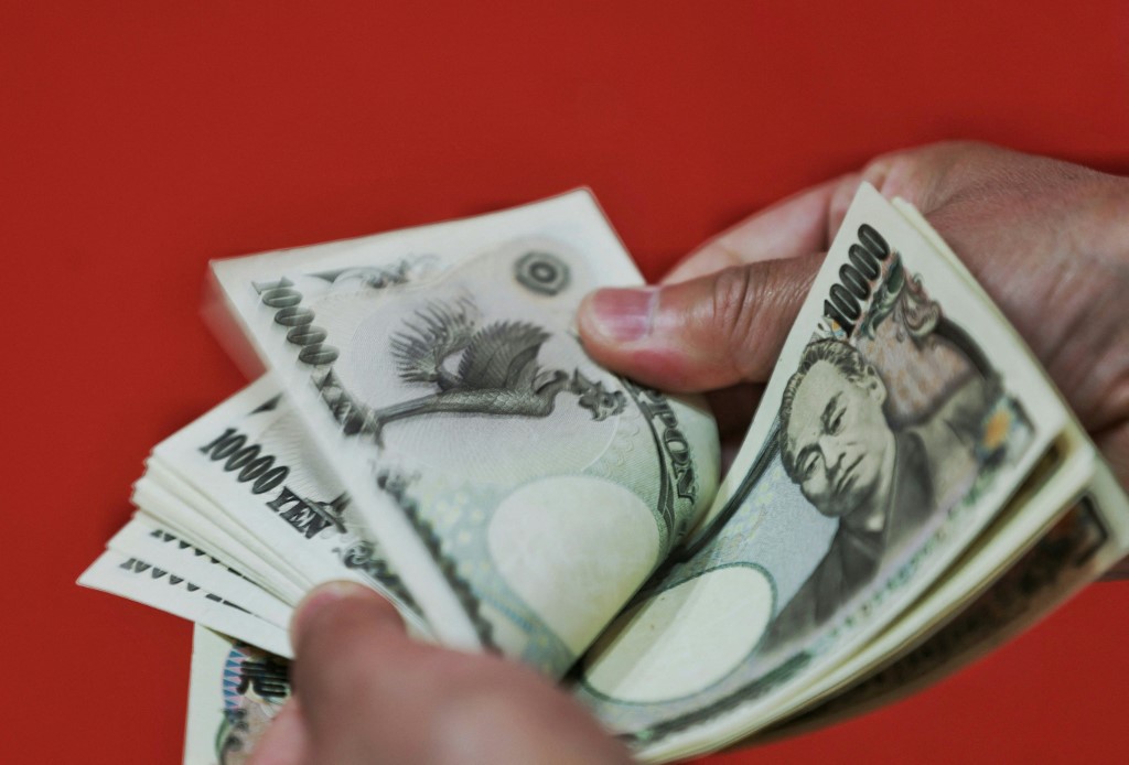 Dollar tops 150 yen for first time in a year